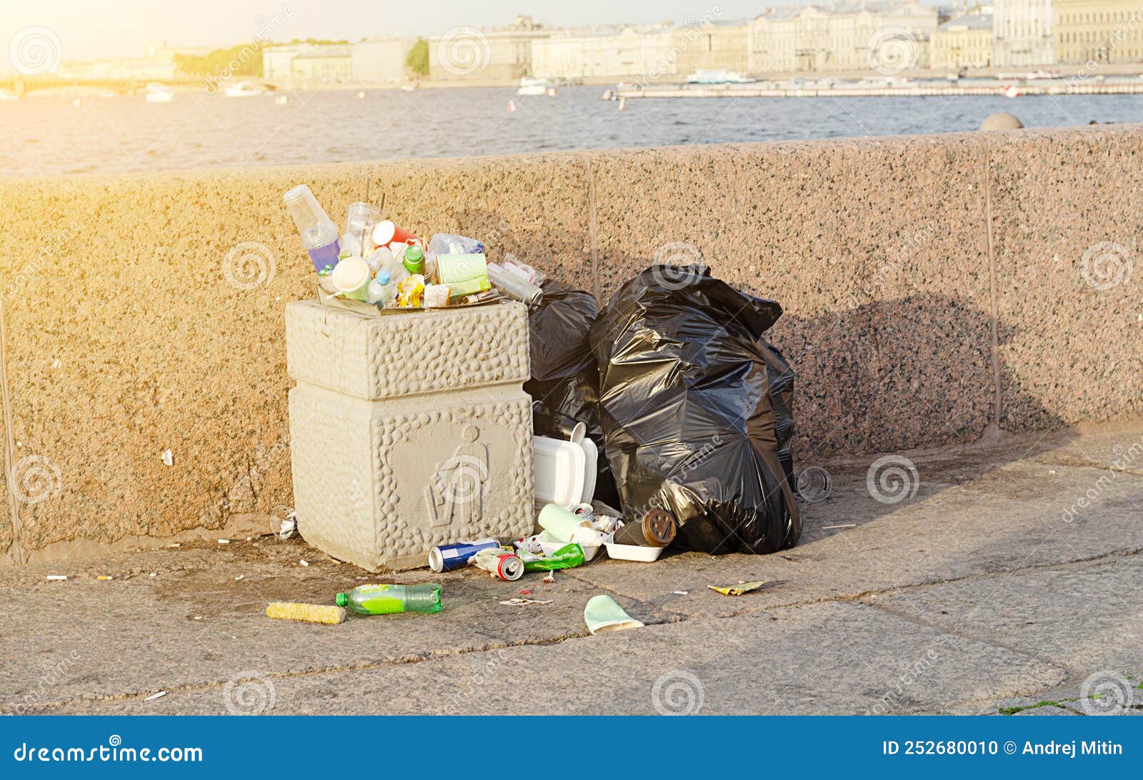 Sunset, an Overflowing Trash Bin , Full Plastic Packaging and Scattered ... Sunset, an Overflowing Trash Bin , Full Plastic Packaging and Scattered ...