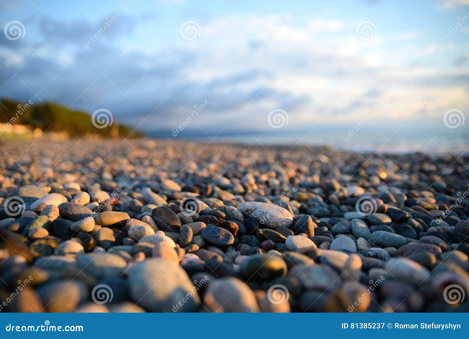 Sunset on pebble beach stock image. Image of dramatic - 81385237