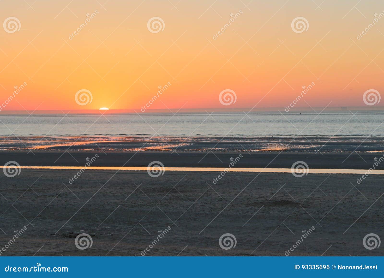 A Sunset Plunging into the Cloudless Sea on the Beach of Dunkerque ...