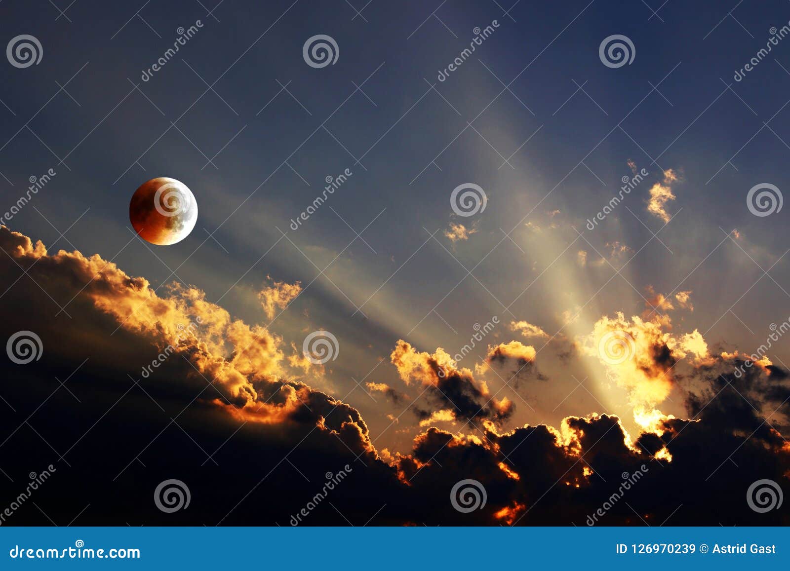 Sunset with Rays of Light and Rising Moon with Lunar Eclipse in the ...