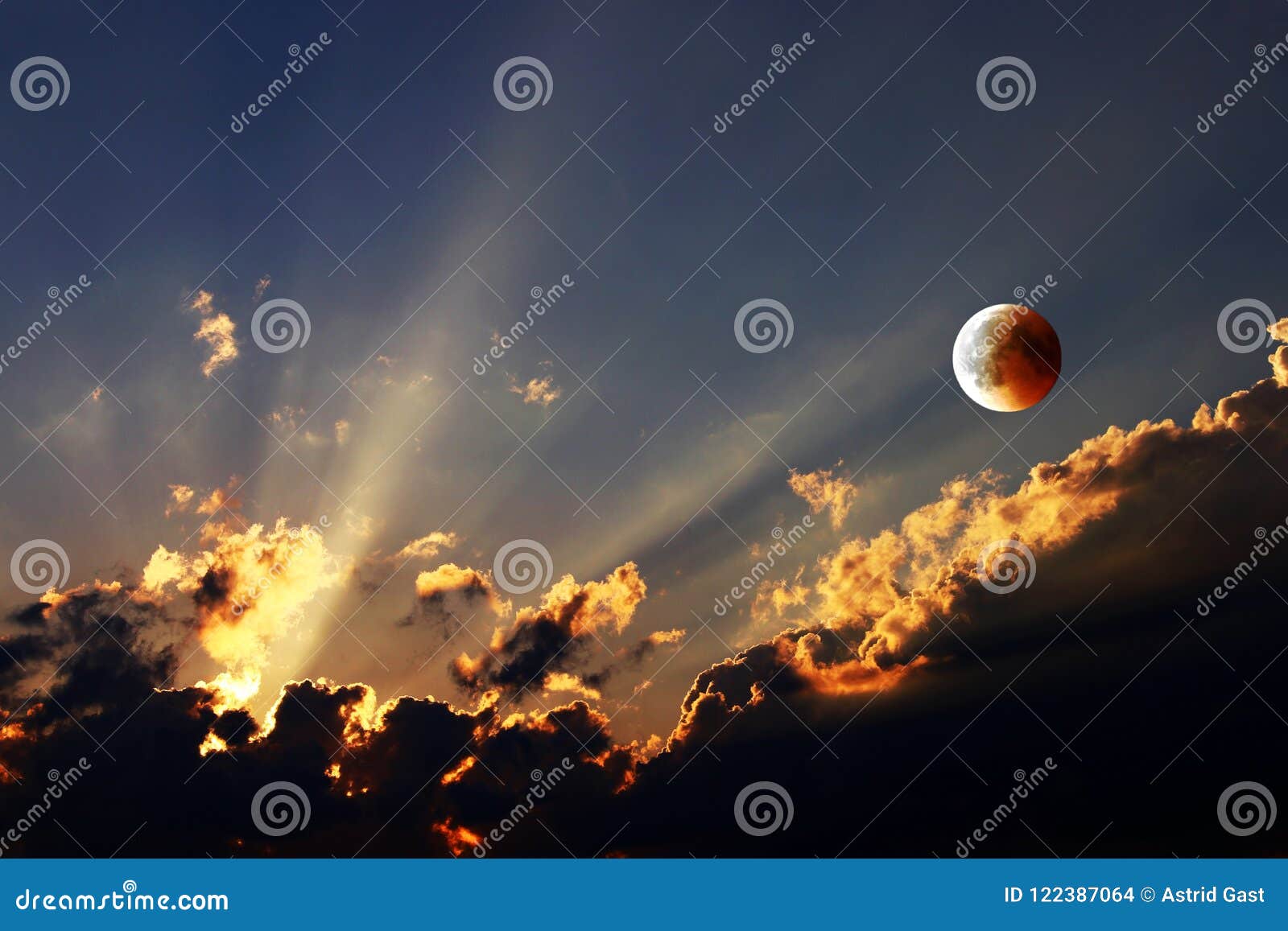 Sunset with Rays of Light and Rising Moon with Lunar Eclipse in the ...