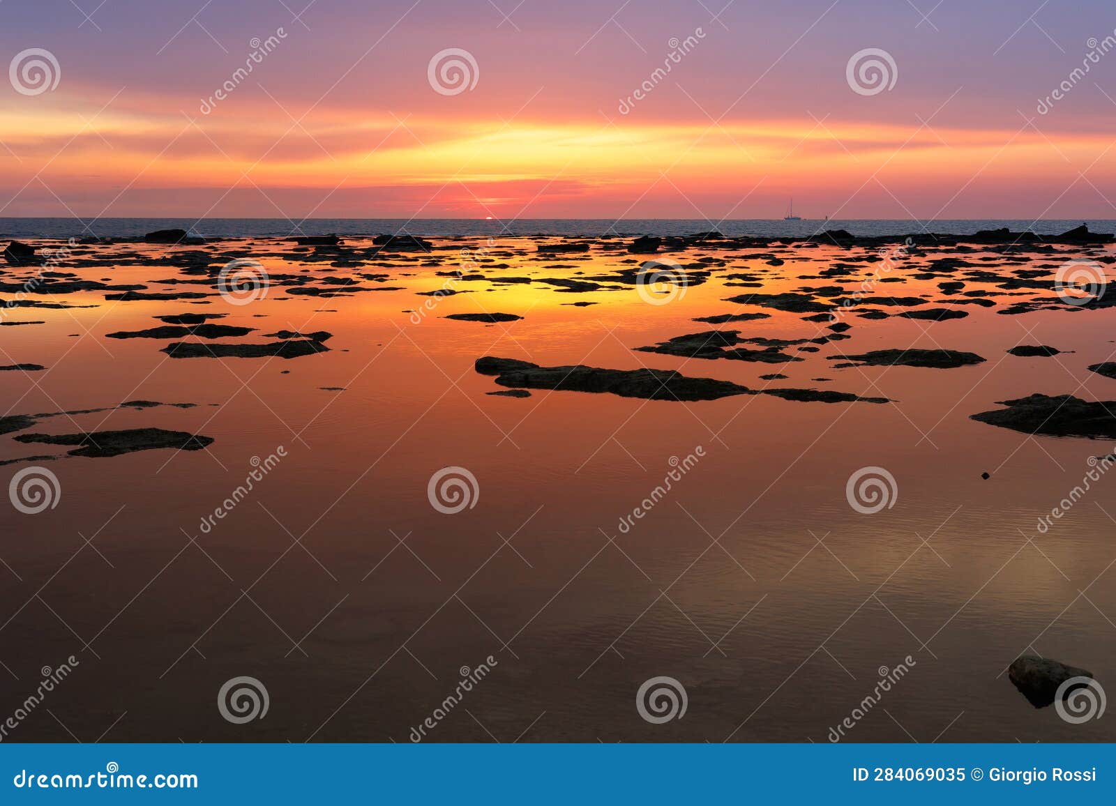 Sunset Reflected on the Sea As in a Mirror with Rocks Emerging on the ...