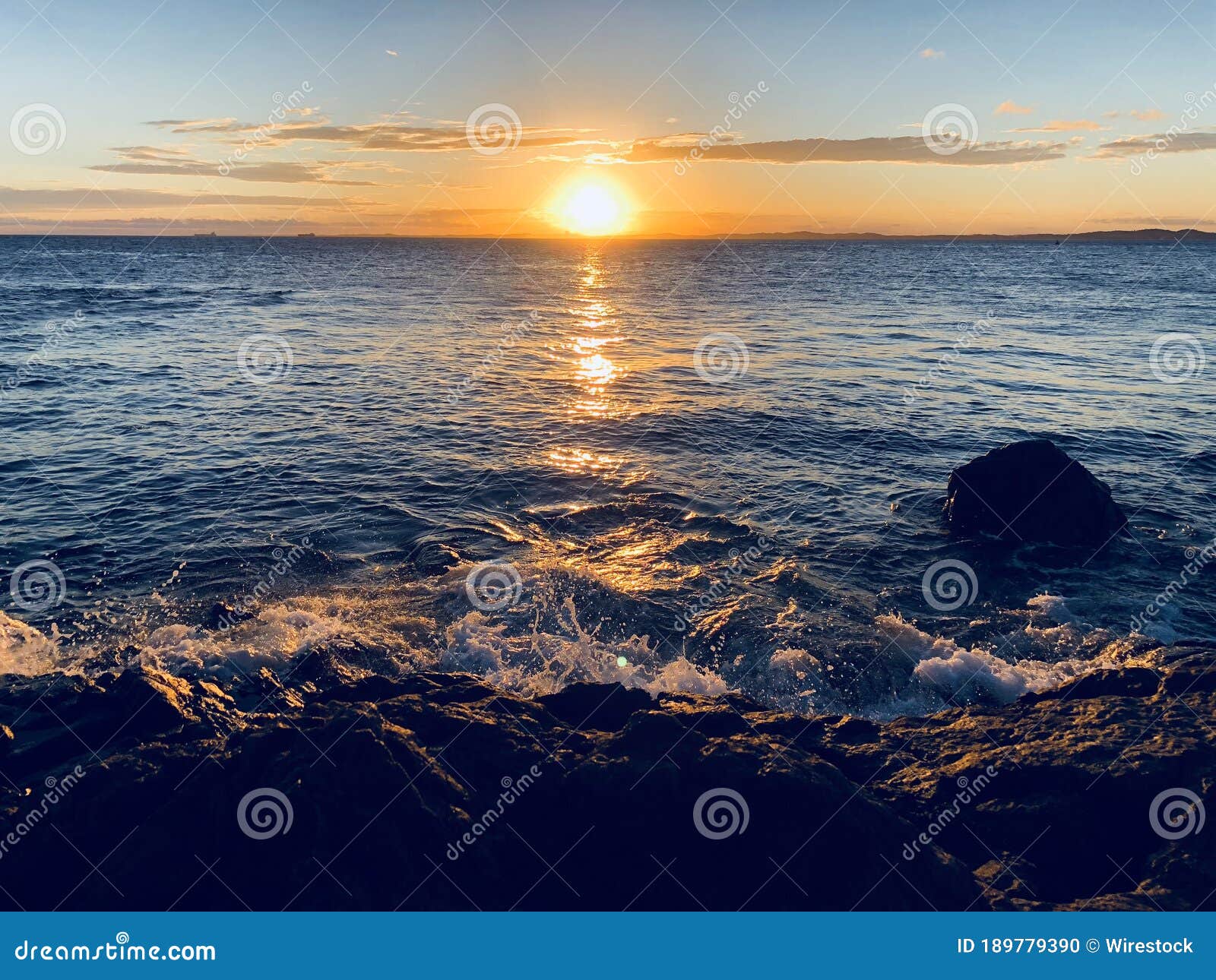 Sunset Reflecting on the Ocean with Waves on the Shore Stock Photo ...