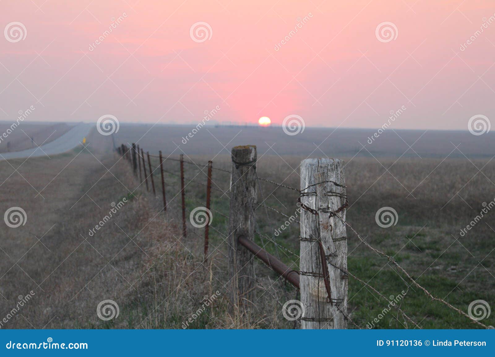 Sunset, Road and fences stock photo. Image of flinthills - 91120136