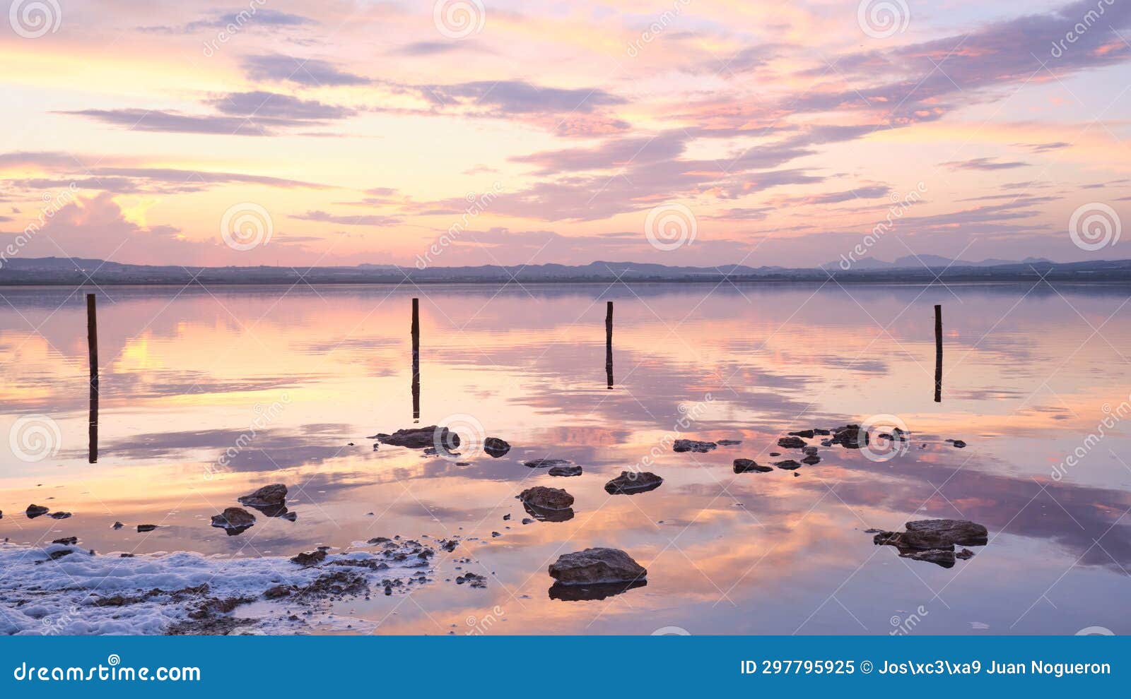 Sunset on the Salt Lagoon with Reflections of Clouds and Silhouettes of ...
