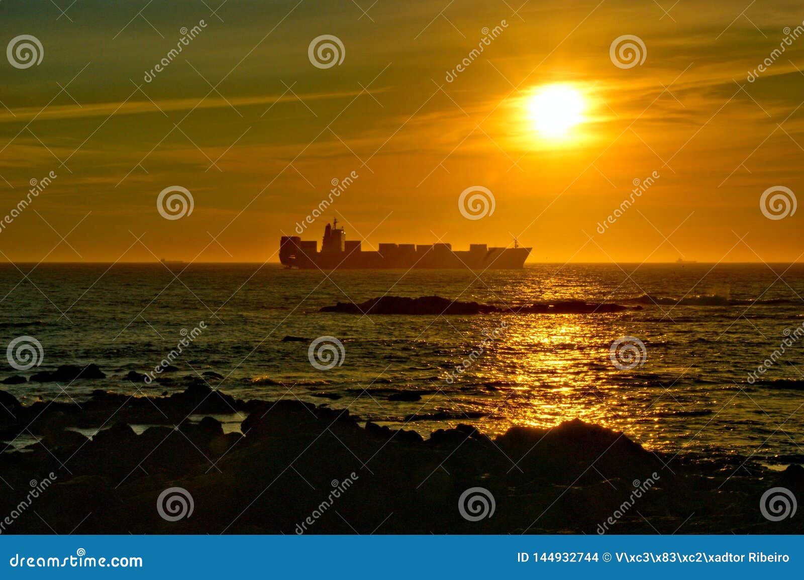 Sunset with a ship cargo stock photo. Image of ship - 144932744