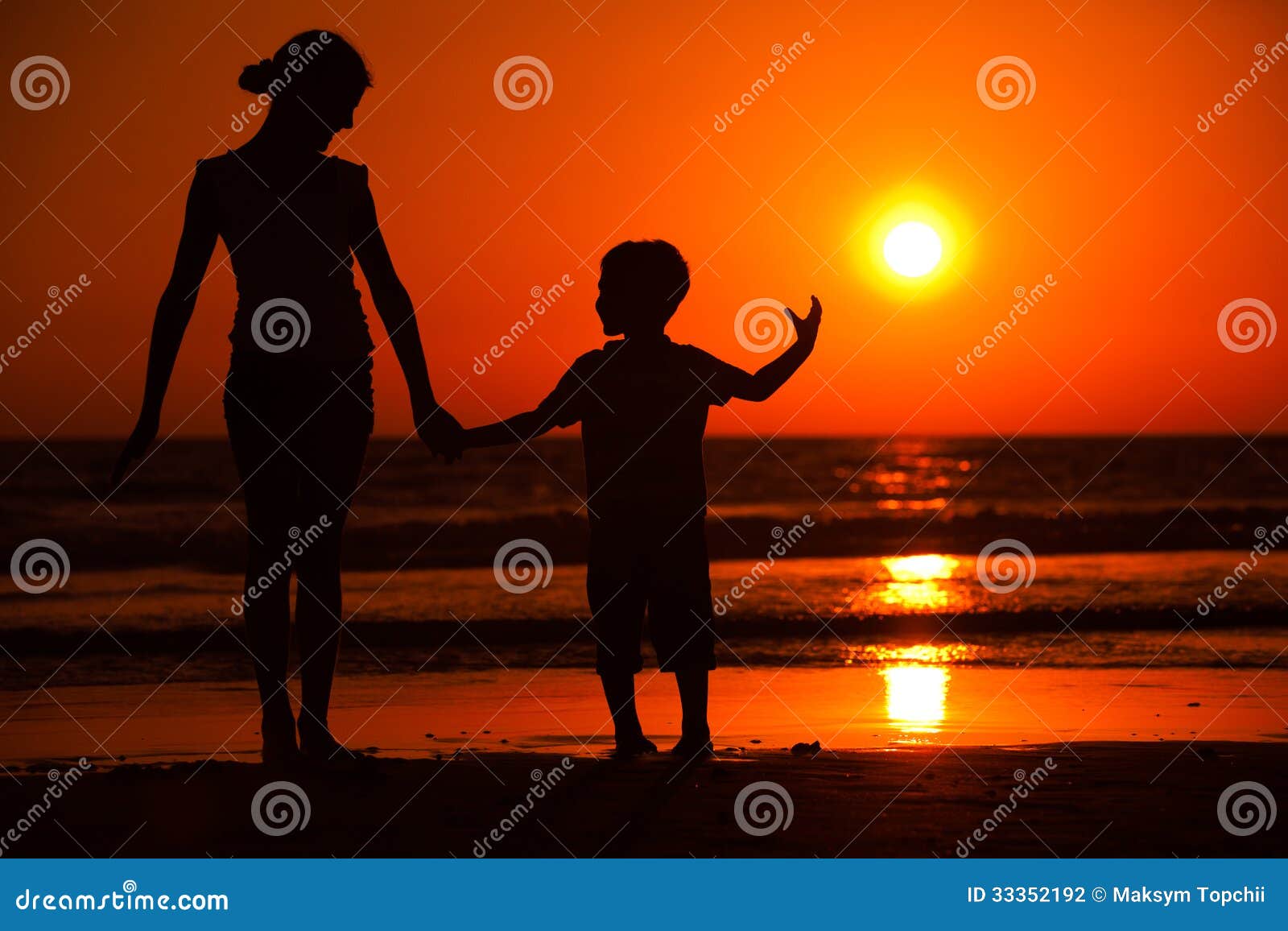 Silhouette Of Brother And Sister Sitting On The Beach Watching Sunset ...