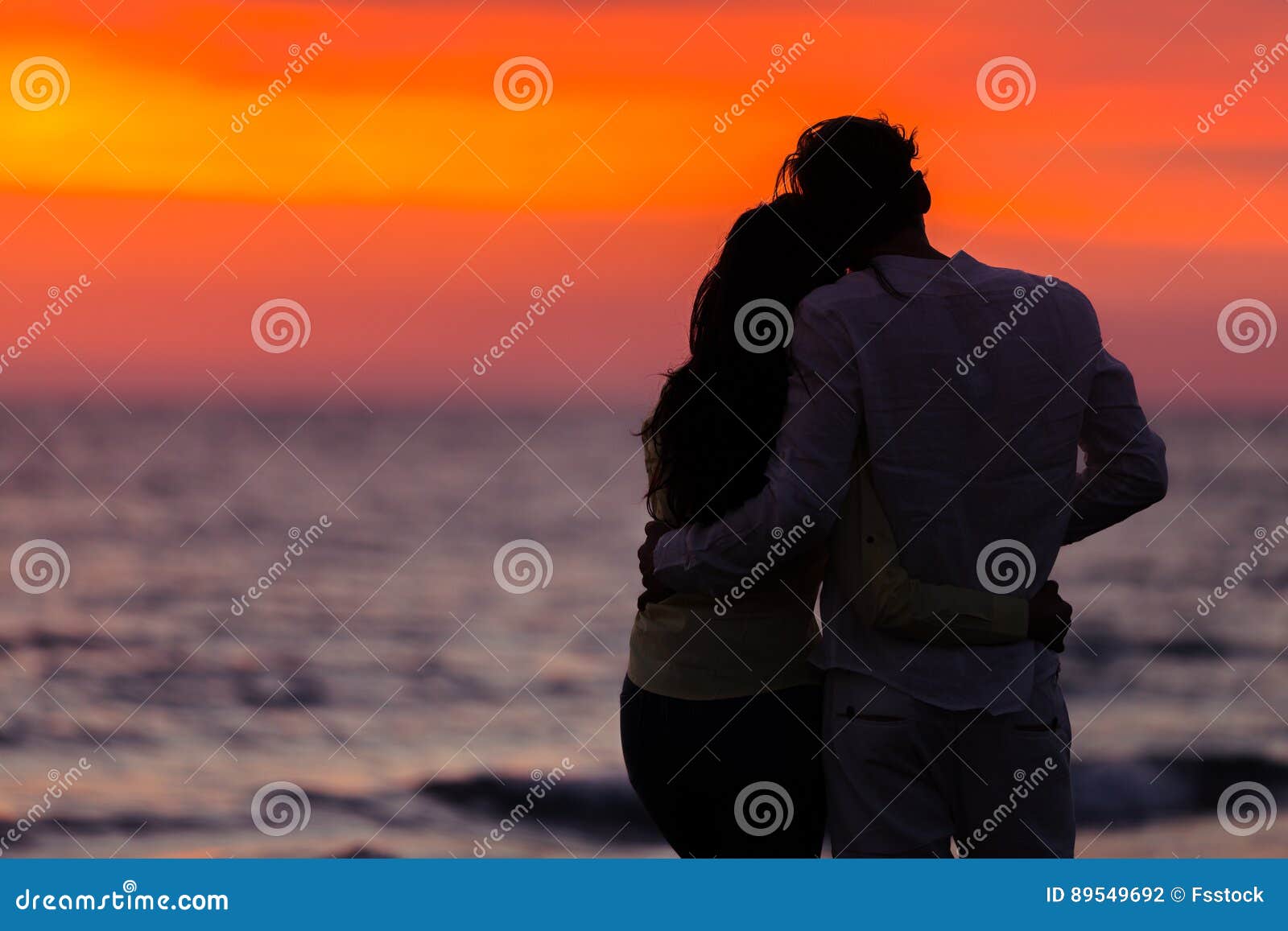 Sunset Silhouette of Young Couple in Love Hugging at Beach Stock Photo ...