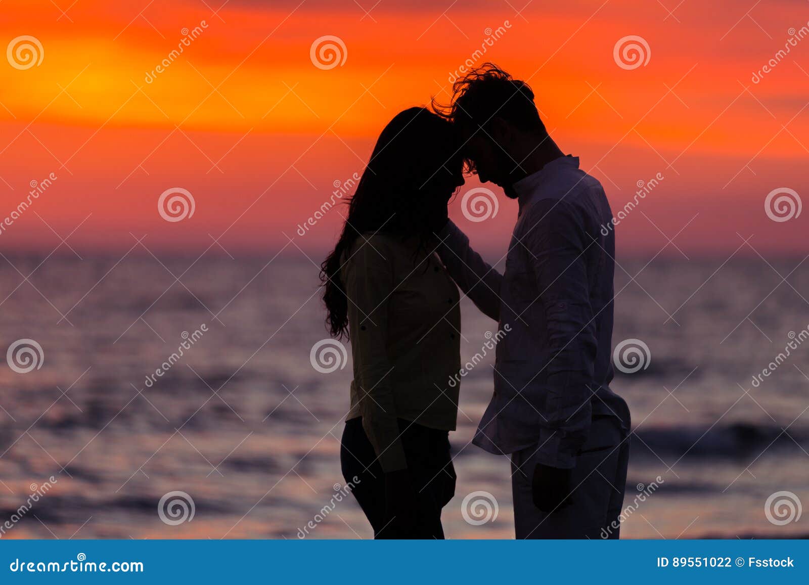 Sunset Silhouette of Young Couple in Love Hugging at Beach Stock Photo ...