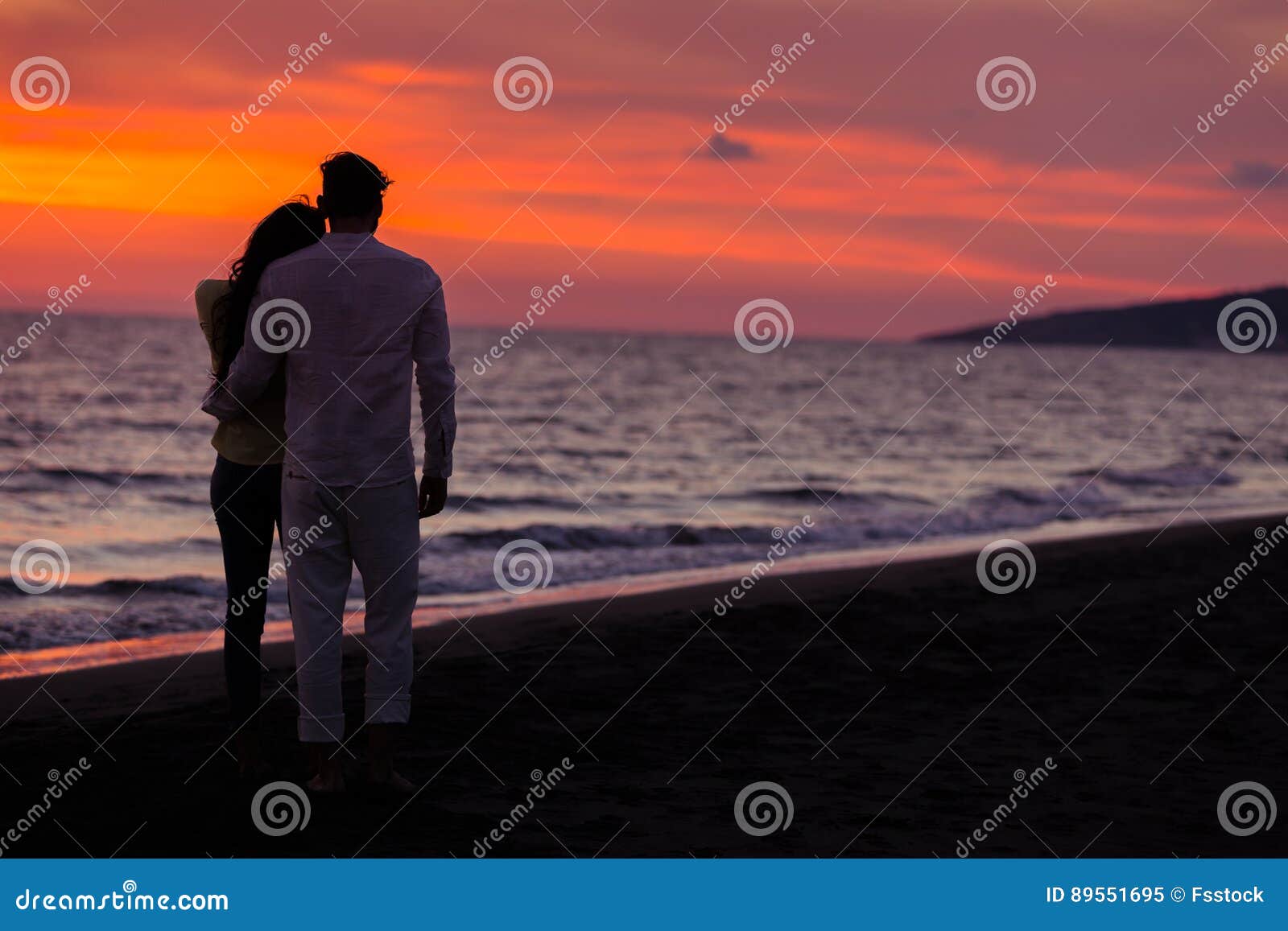 Sunset Silhouette Of Young Couple In Love Hugging At Beach Royalty-Free ...