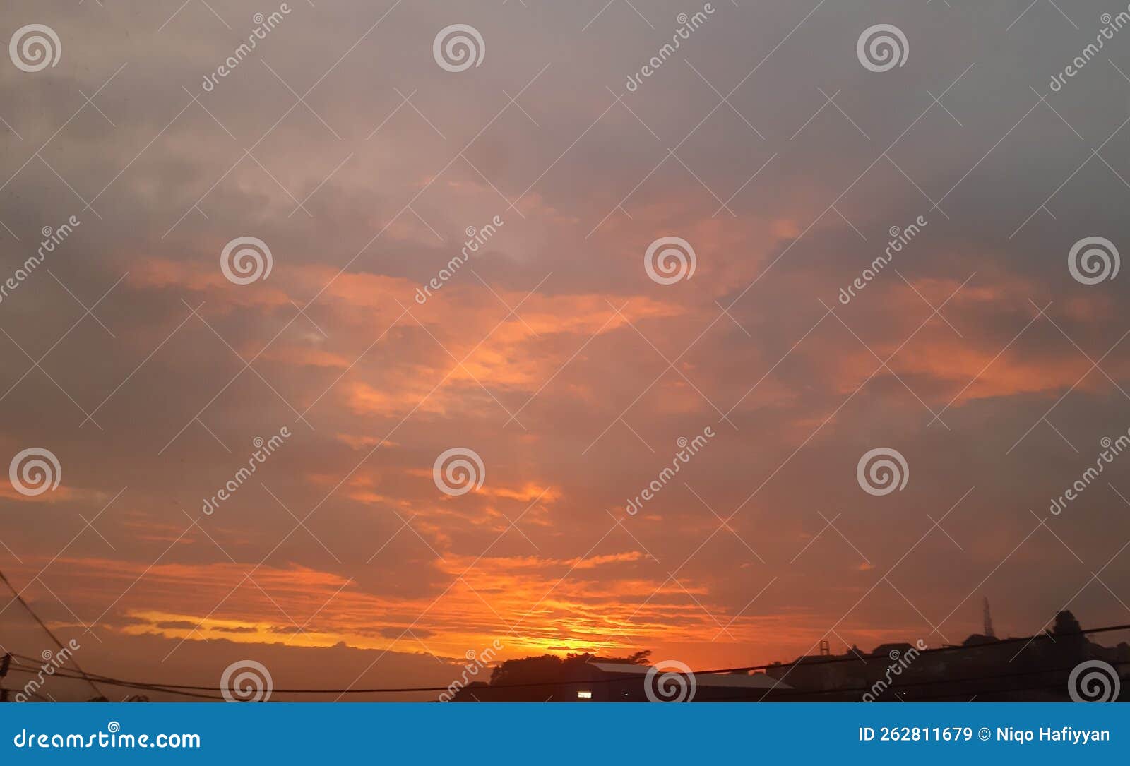 Sunset in the Sky with Cloudy Weather and Several Buildings at the ...