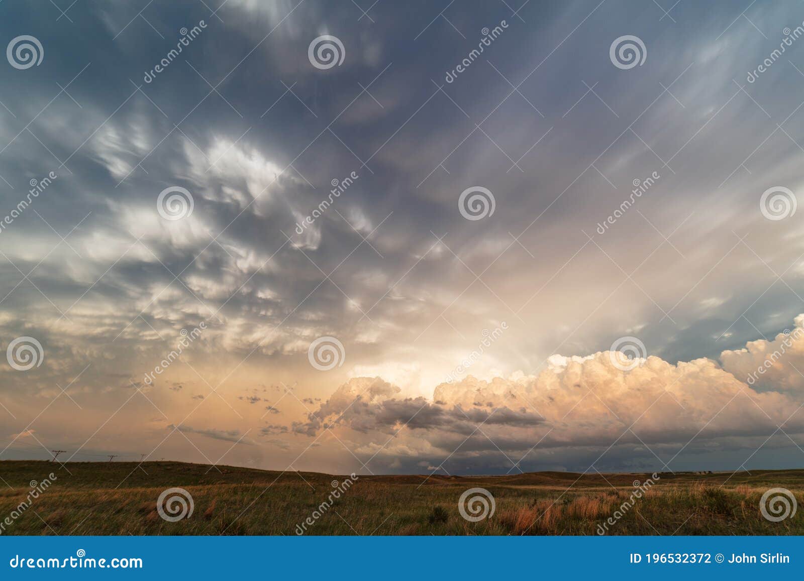 Sunset Sky with Dramatic Clouds and a Distant Storm Over a Field Stock ...