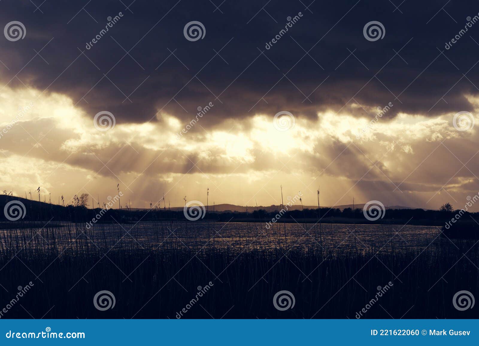 Sunset Sky Over a Lake.Dark and Dramatic Scene, Sun Rays Burst from the ...