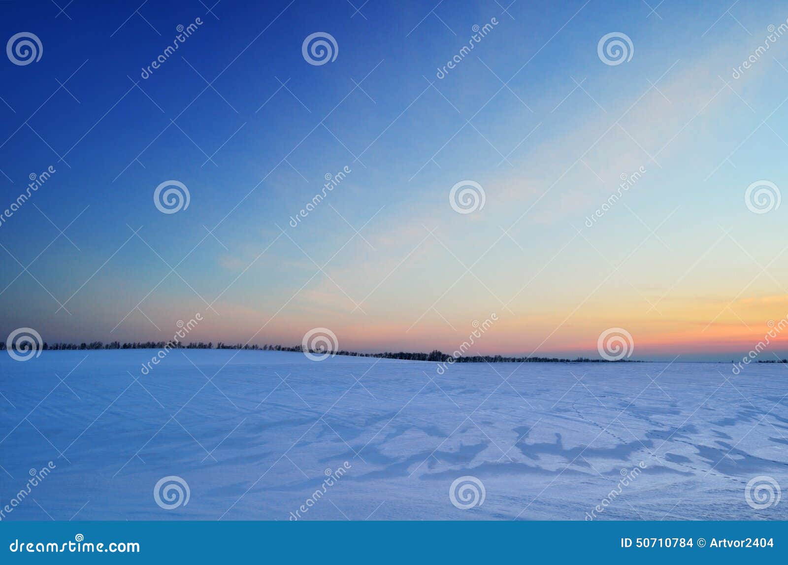 Sunset on a snowy field stock photo. Image of orange - 50710784