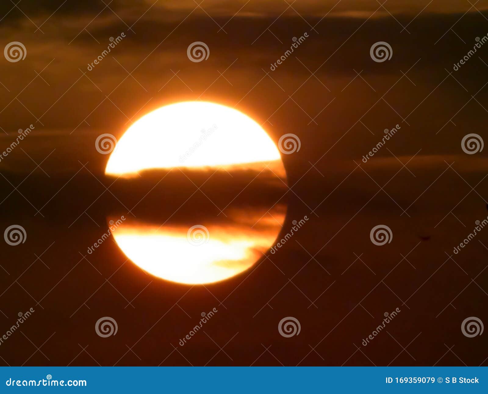 Sunset with Sun and Overlapping Cloud. Spring Scene. Sun Hiding in ...