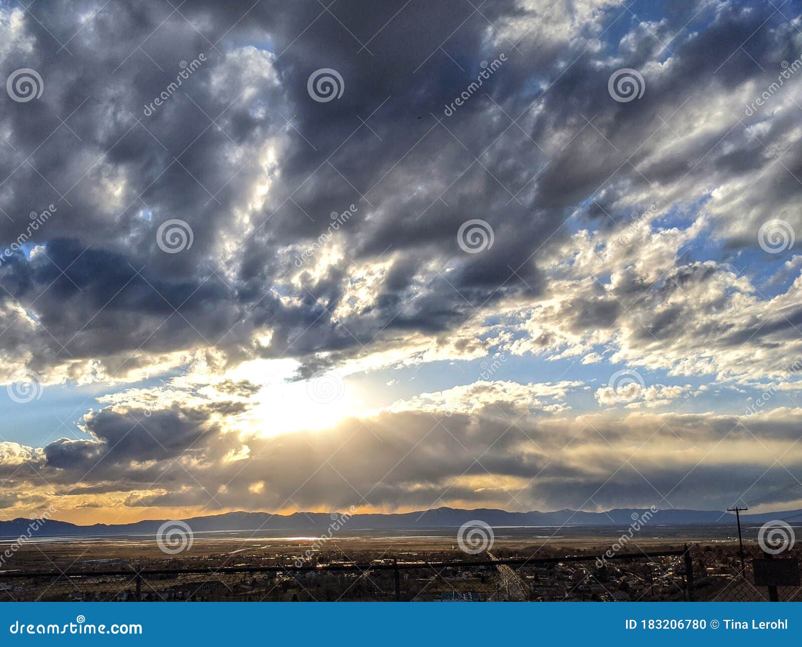 Sunset with Sun Rays Coming through Clouds and Blue Sky Stock Photo ...