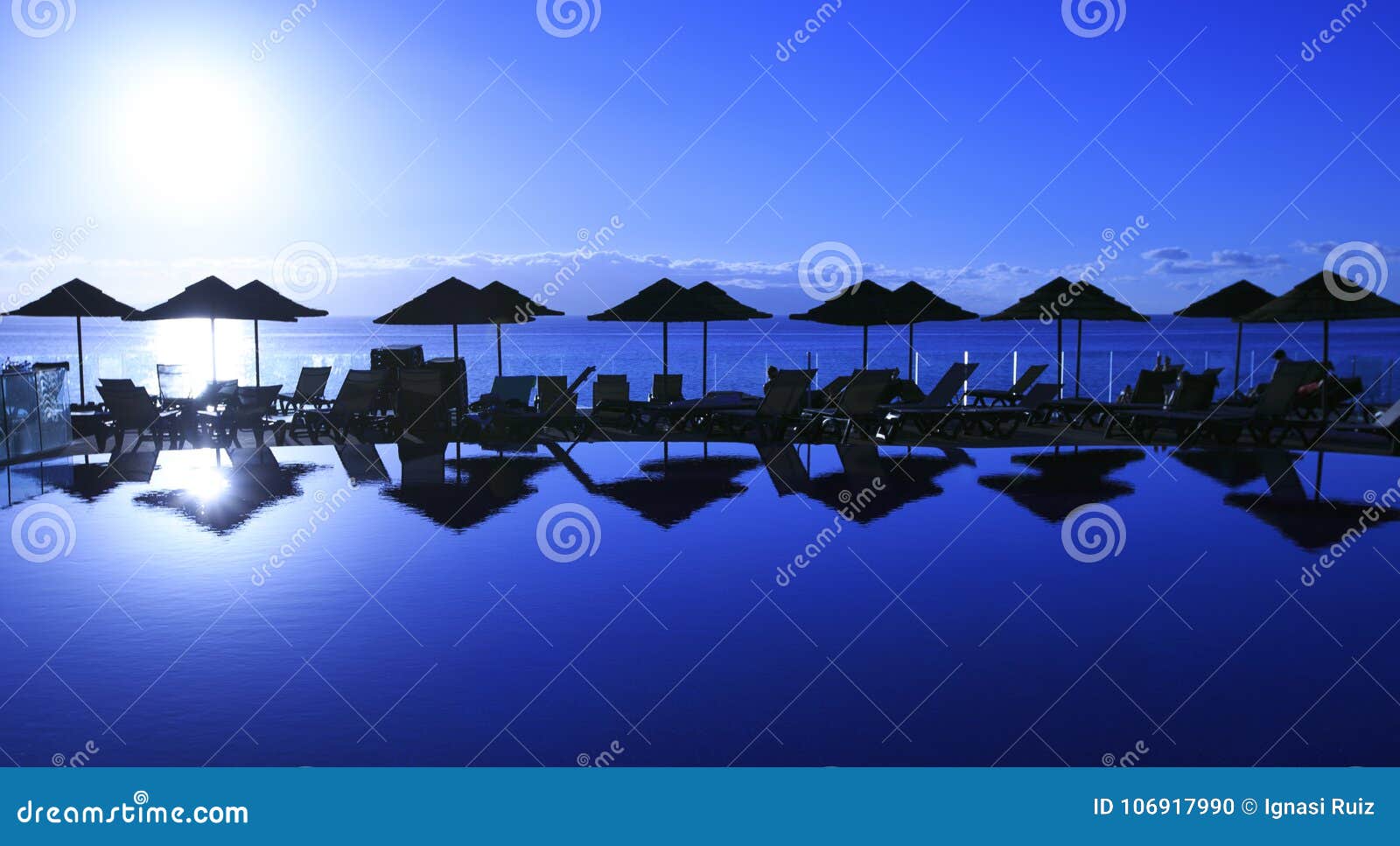 Sunset in a swimming pool stock photo. Image of holiday - 106917990