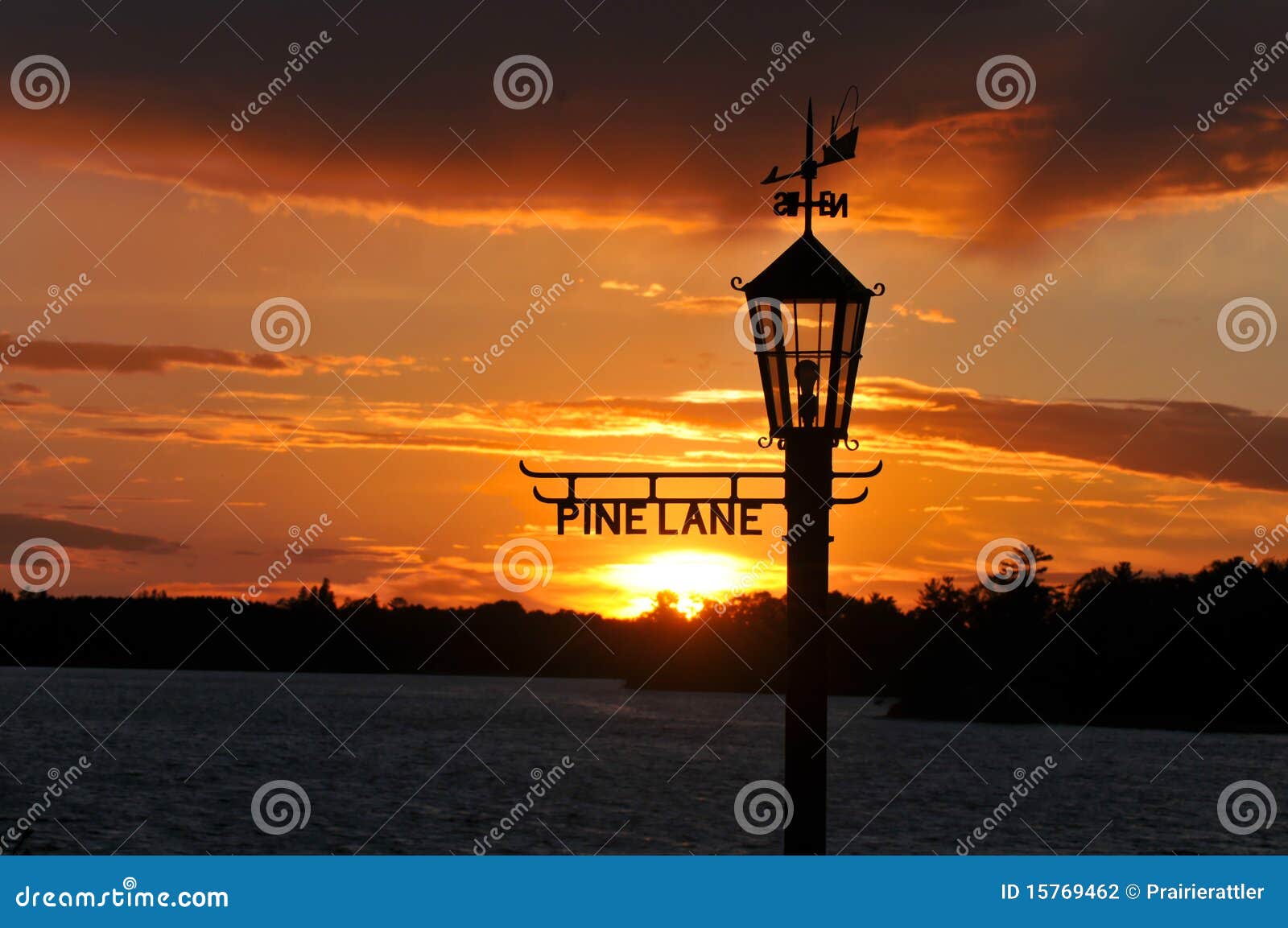 Sunset thru Lamp Post stock photo. Image of evening, sign - 15769462