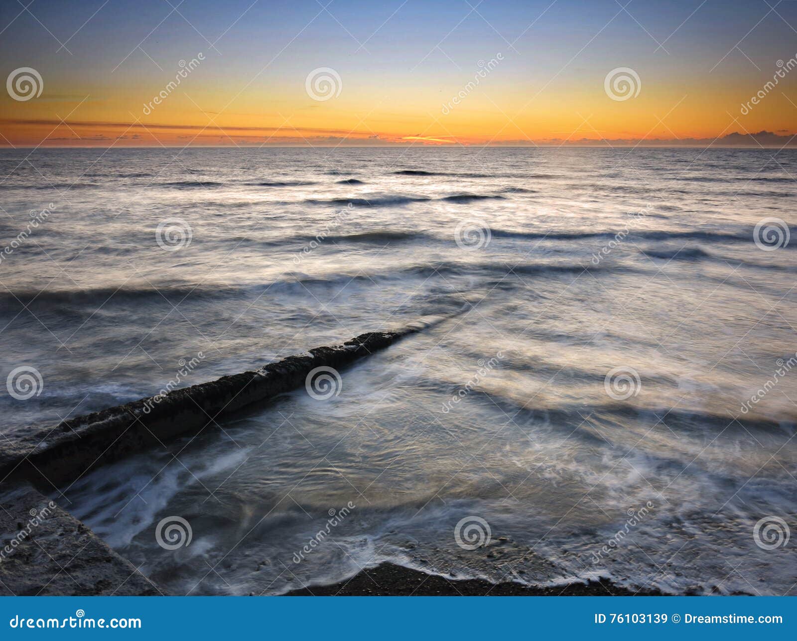 Sunset and the tide stock image. Image of beach, waves - 76103139