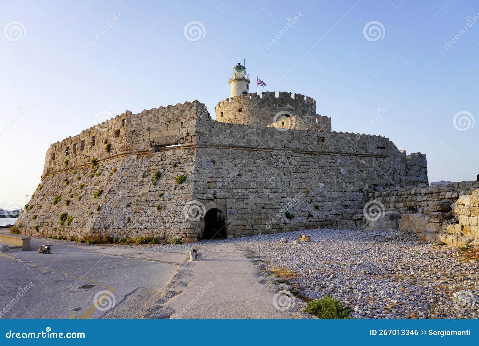 Sunset on Tower and Fort of Saint Nicholas, Rhodes, Greece Stock Photo ...