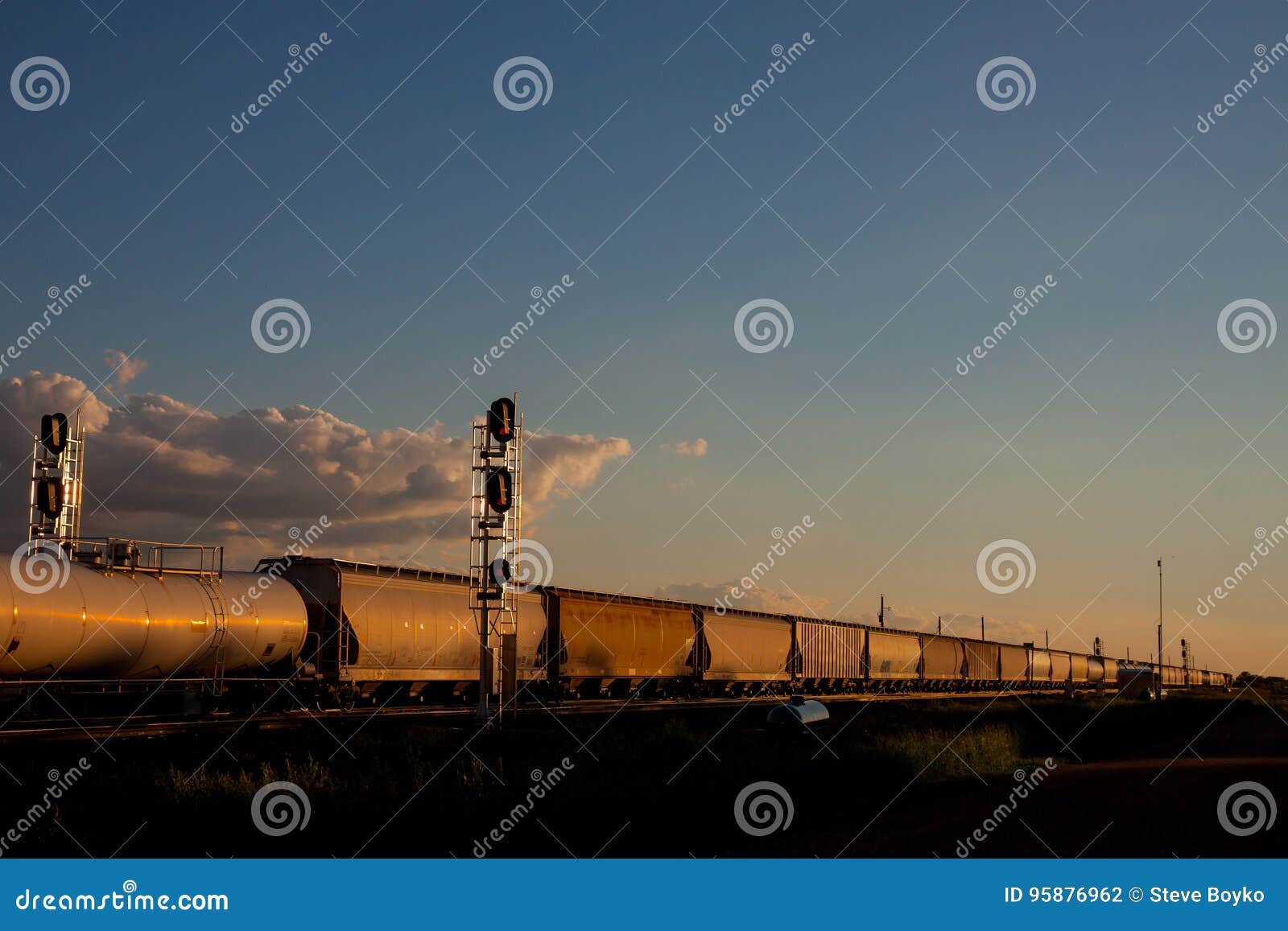 Sunset Train Passing Signal Towers Stock Photo - Image of tracks ...