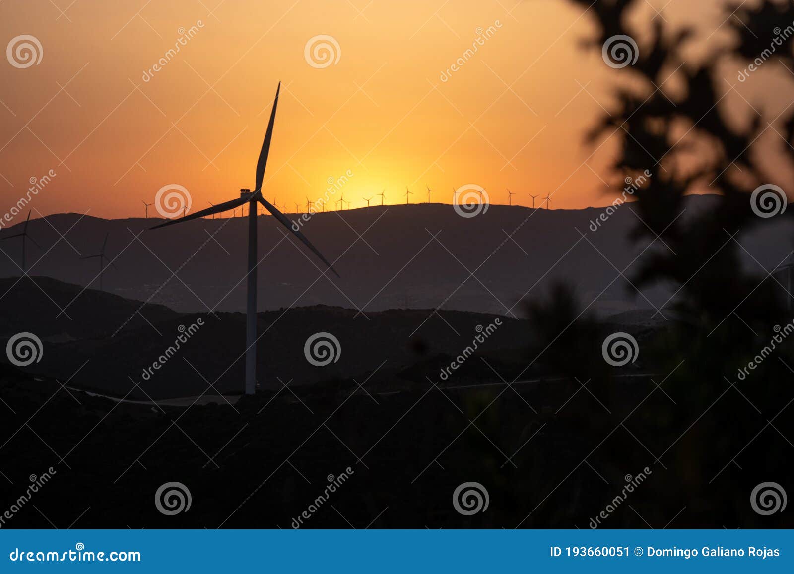 Sunset with wind turbines stock image. Image of orange - 193660051