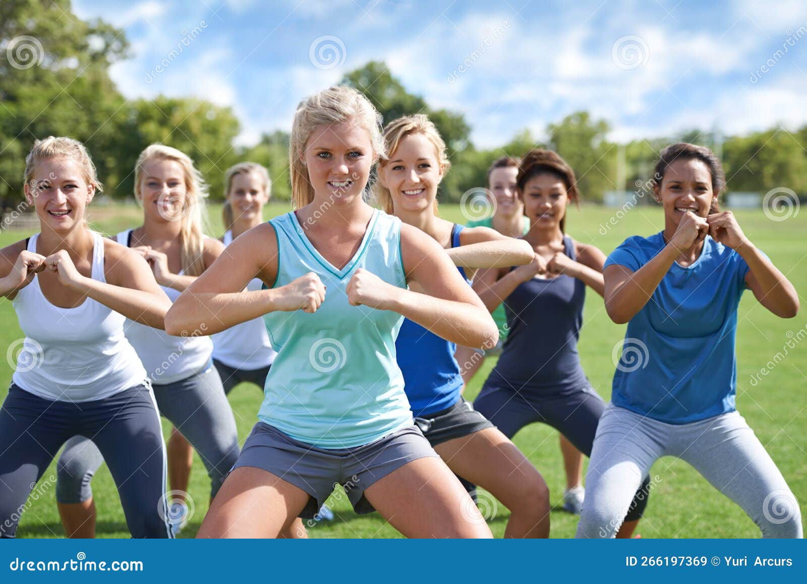 Sunshine and Exercise. a Group of Young Women Exercising Outdoors ...