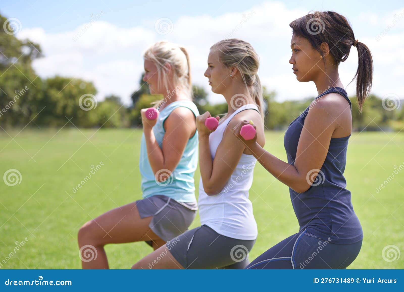 Sunshine and Exercise. a Group of Young Women Exercising Outdoors ...