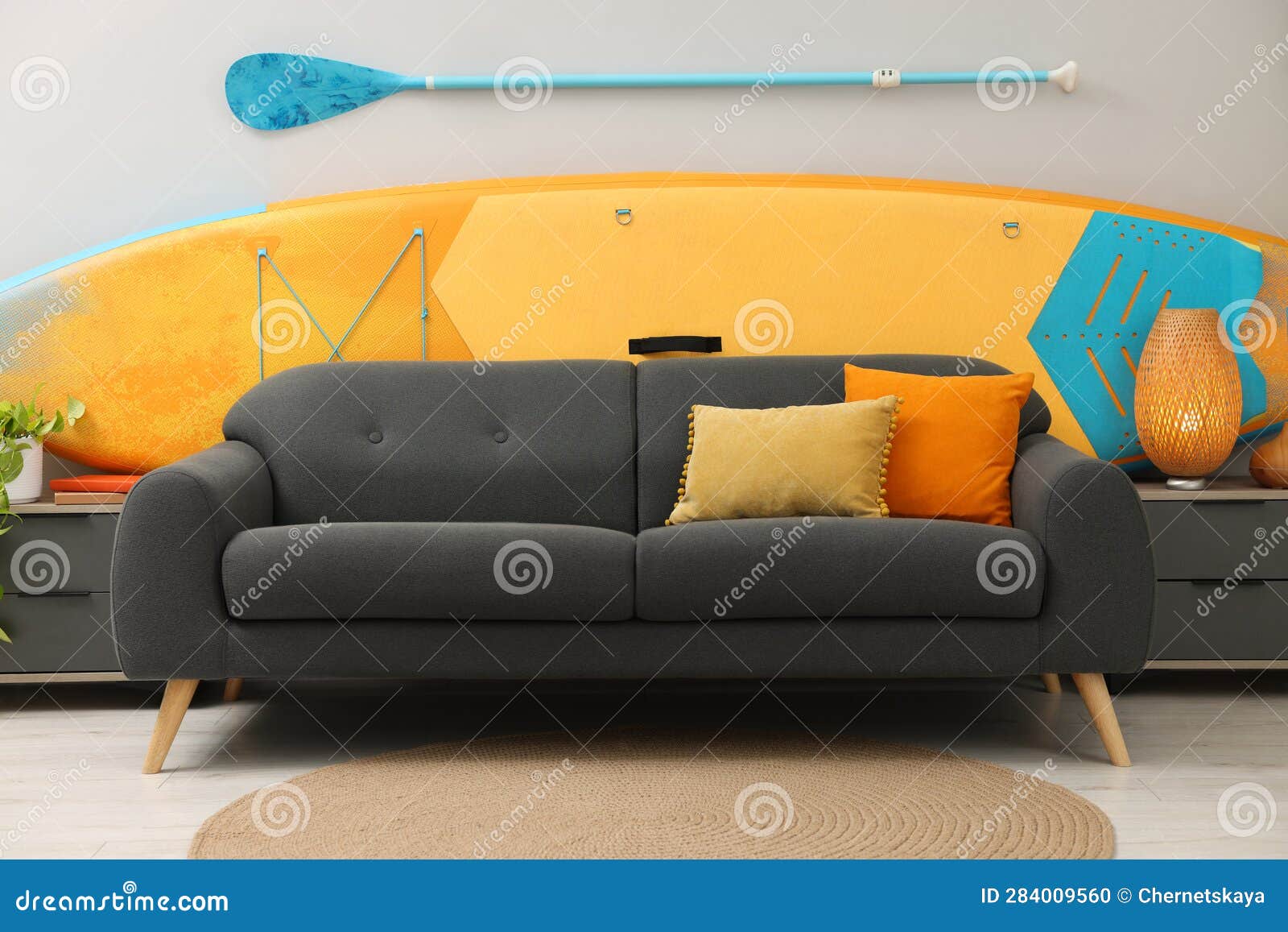 SUP Board, Paddle and Stylish Sofa in Living Room. Interior Design ...