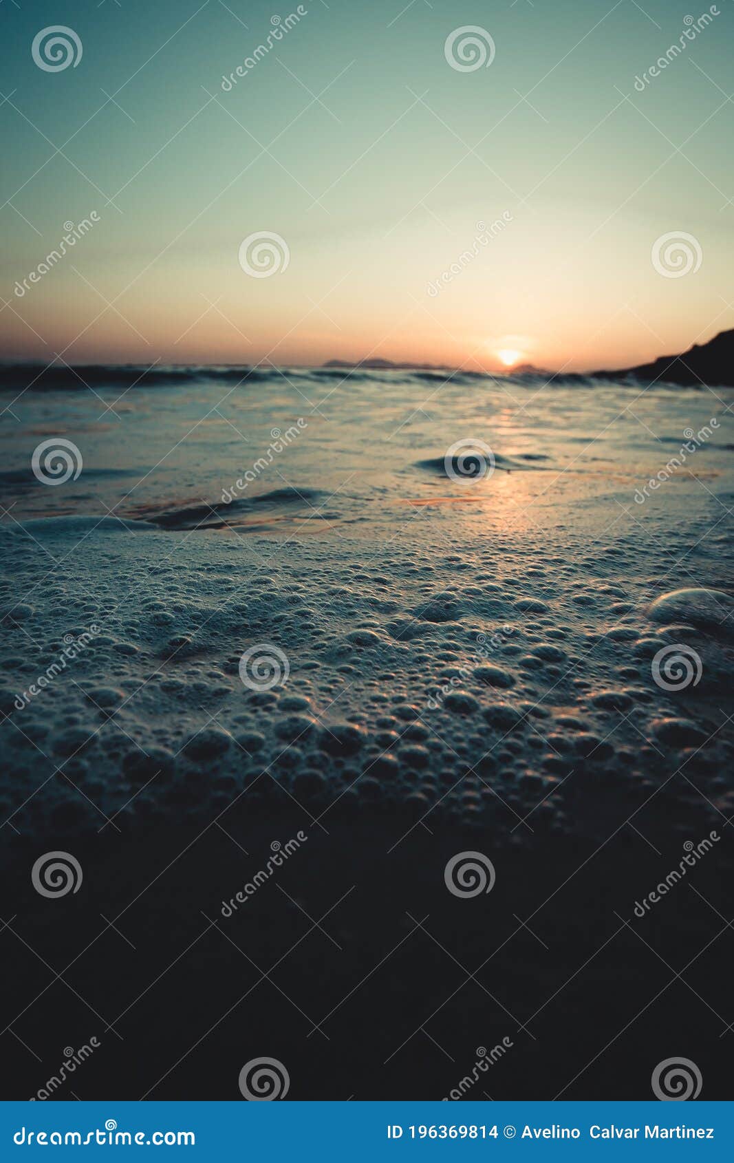 Super Close Up of the Bubbles in the Tide of the Beach during a Sunset ...
