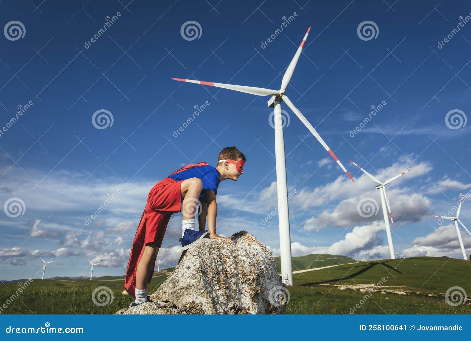 Superhero Kid is in Front of the Wind Farm. Stock Image - Image of ...