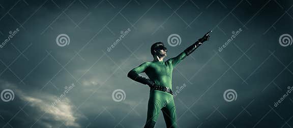 Superhero Pointing with Dramatic Background Stock Image - Image of ...