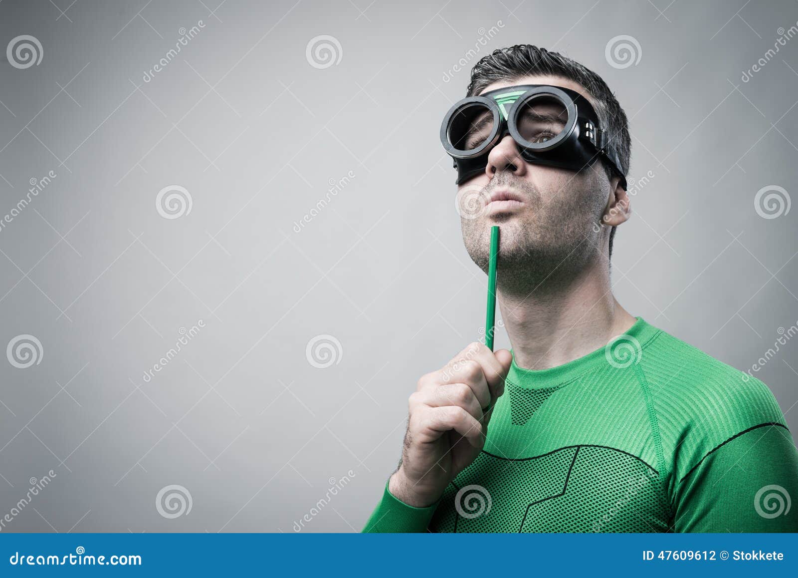Superhero Thinking with Green Pencil Stock Photo - Image of looking ...