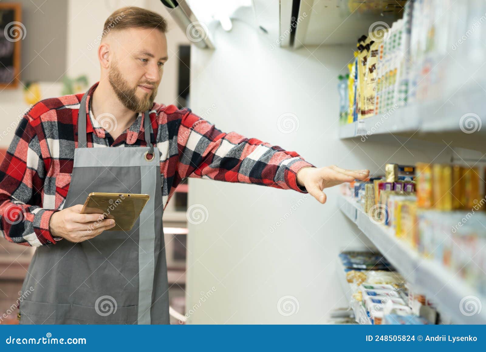 Supermarket Clerk Using Apps on a Digital Tablet, Handsome Supervisor ...