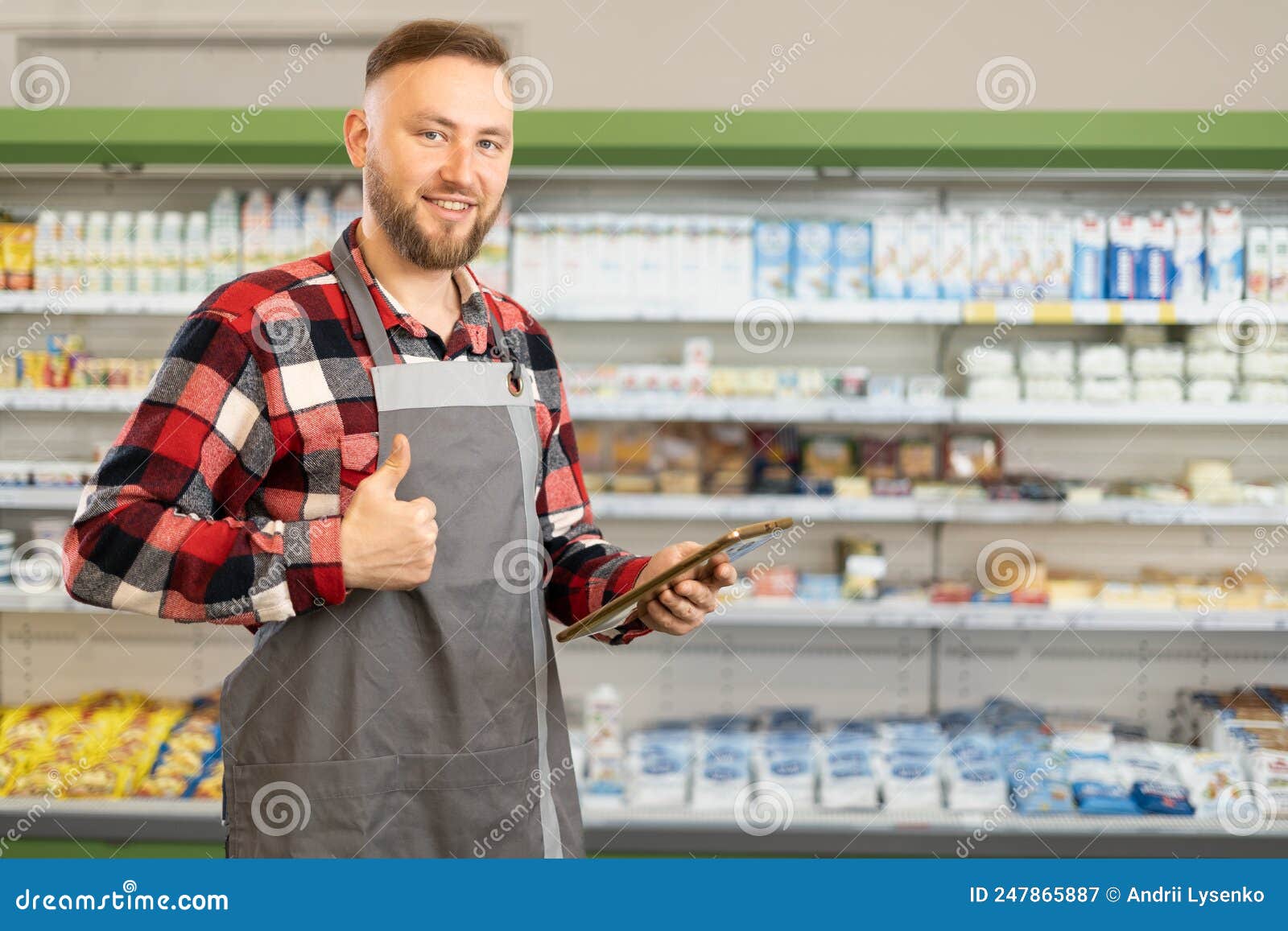 Supermarket Clerk Using Apps on a Digital Tablet, Innovative Technology ...