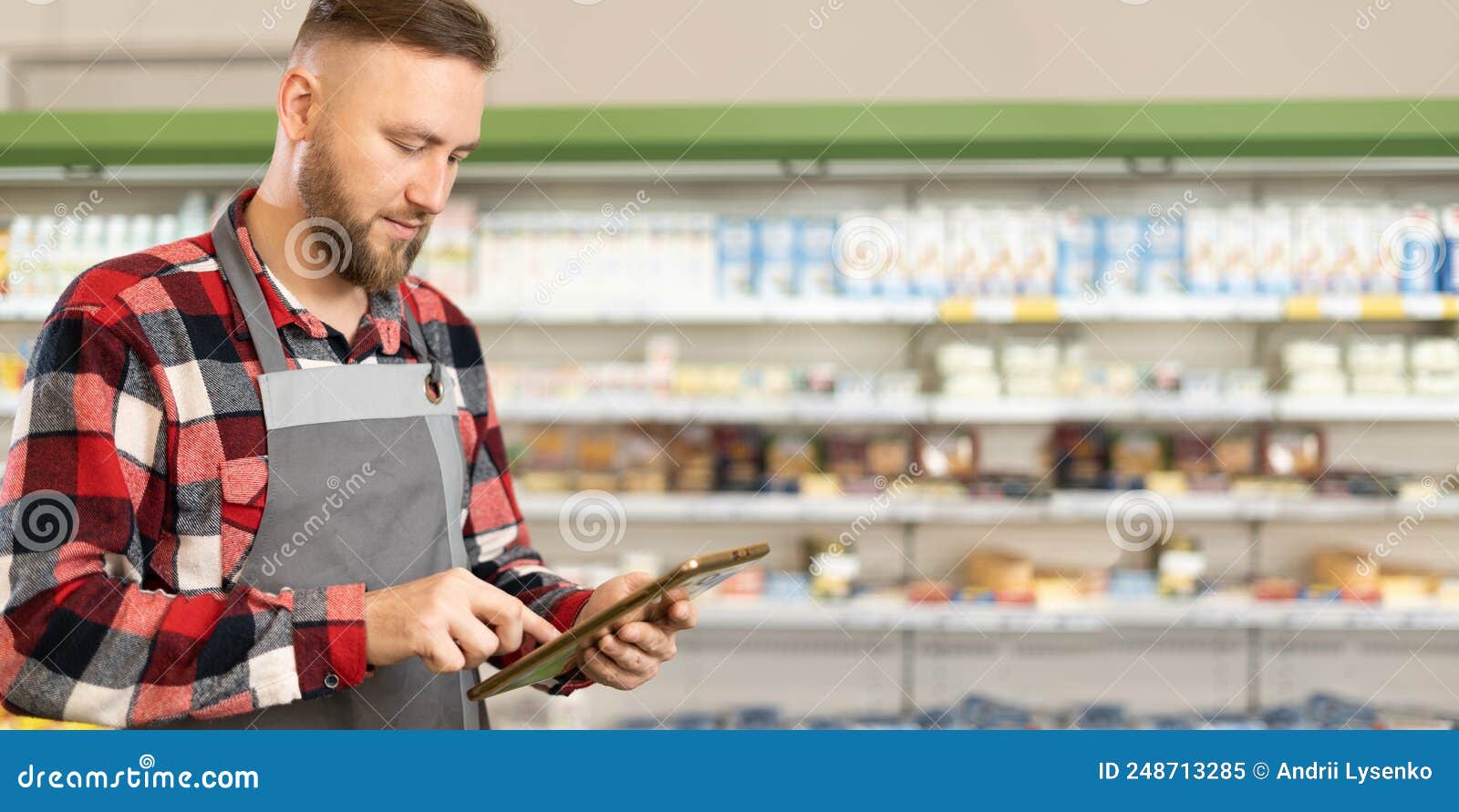 Supermarket Clerk Using Apps on a Digital Tablet, Young Handsome ...