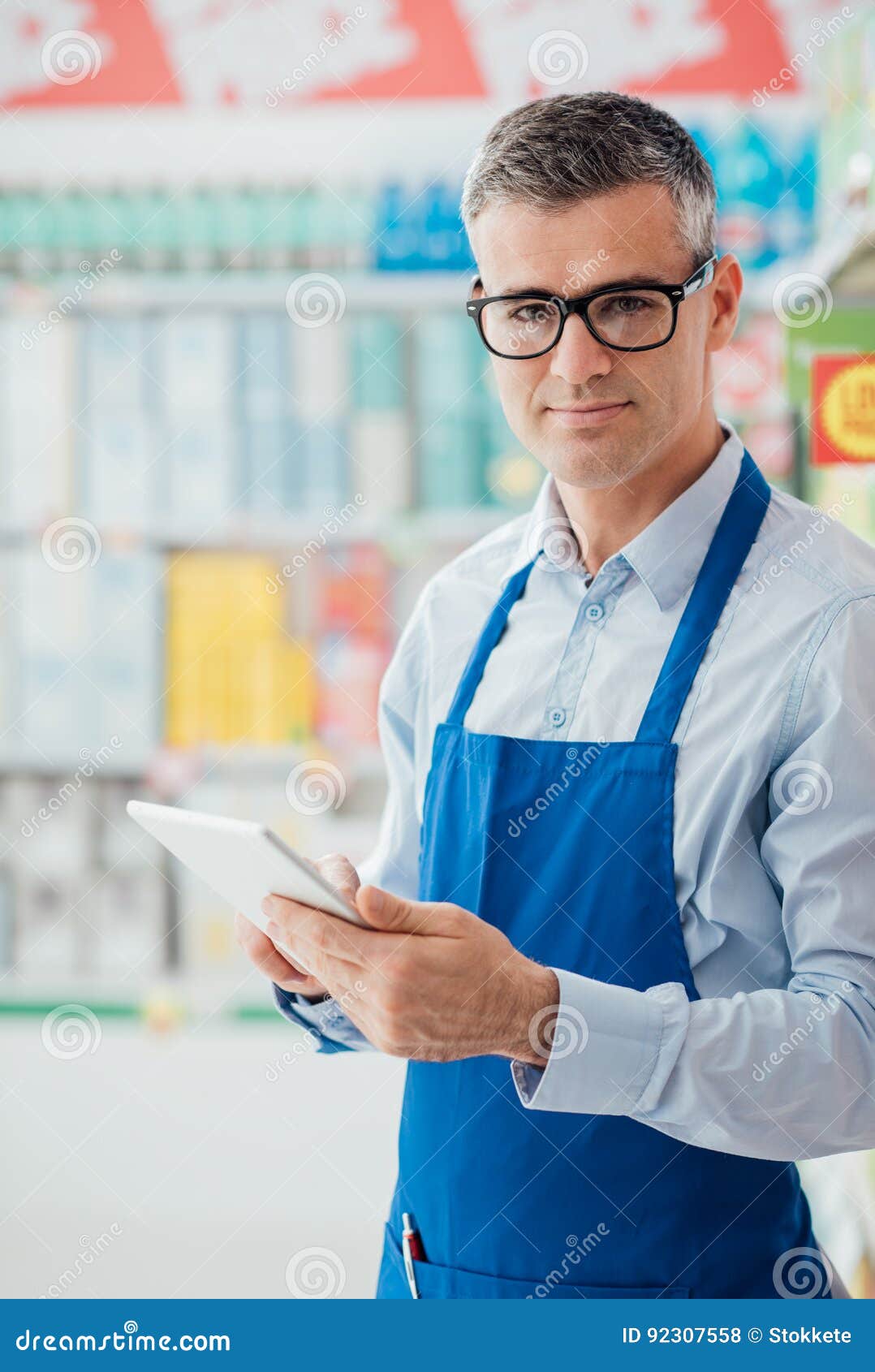 Supermarket Clerk Using a Tablet Stock Photo - Image of shopping ...