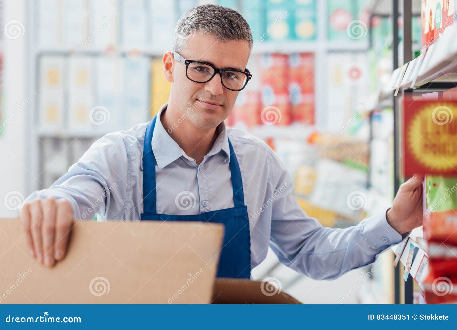 Supermarket clerk at work stock image. Image of mall - 83448351