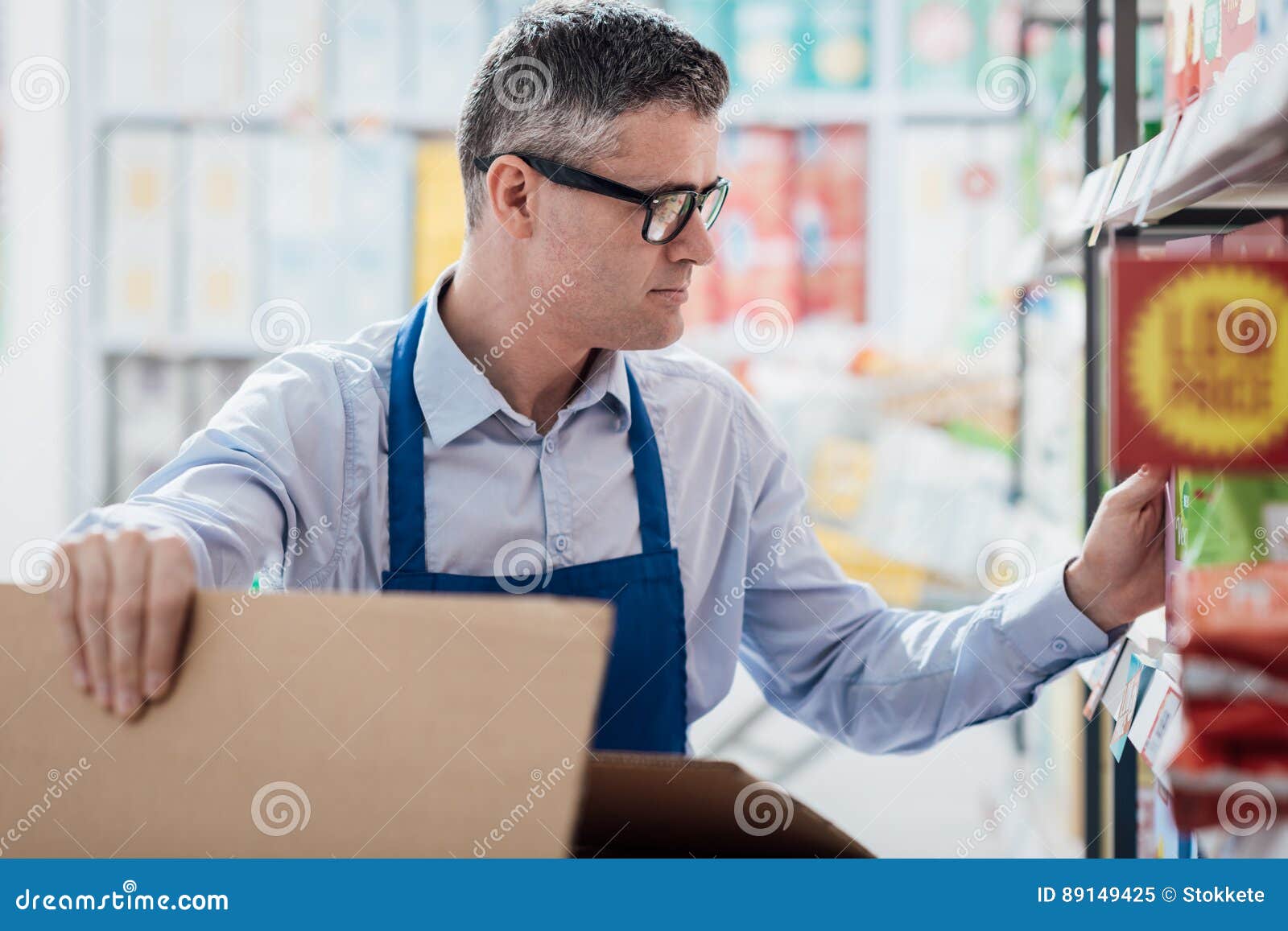 Supermarket clerk at work stock image. Image of apron - 89149425