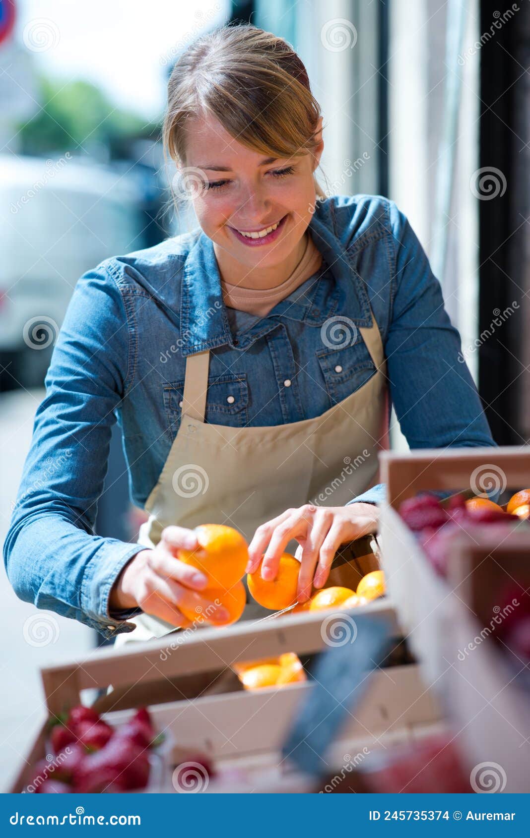 Supermarket Worker in Apron Arranging Fruits Stock Photo - Image of ...