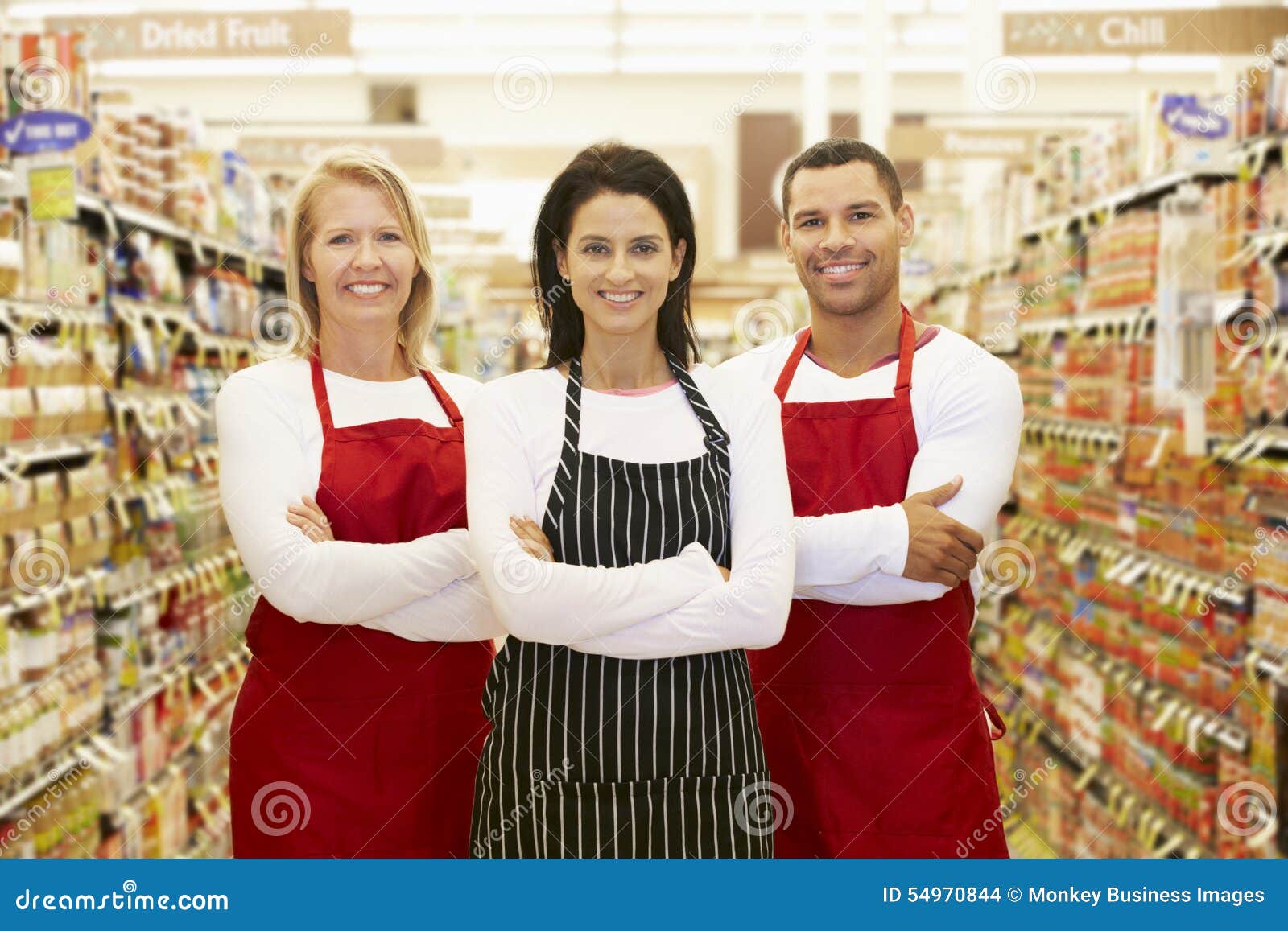 Supermarket Workers Standing in Grocery Aisle Stock Photo - Image of ...