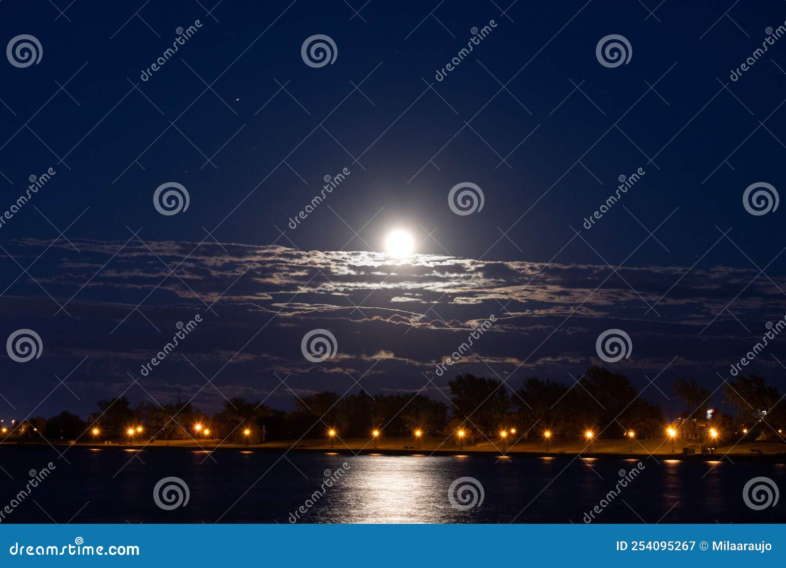Supermoon Over the Water with Clouds and Moonlight Reflection Stock ...