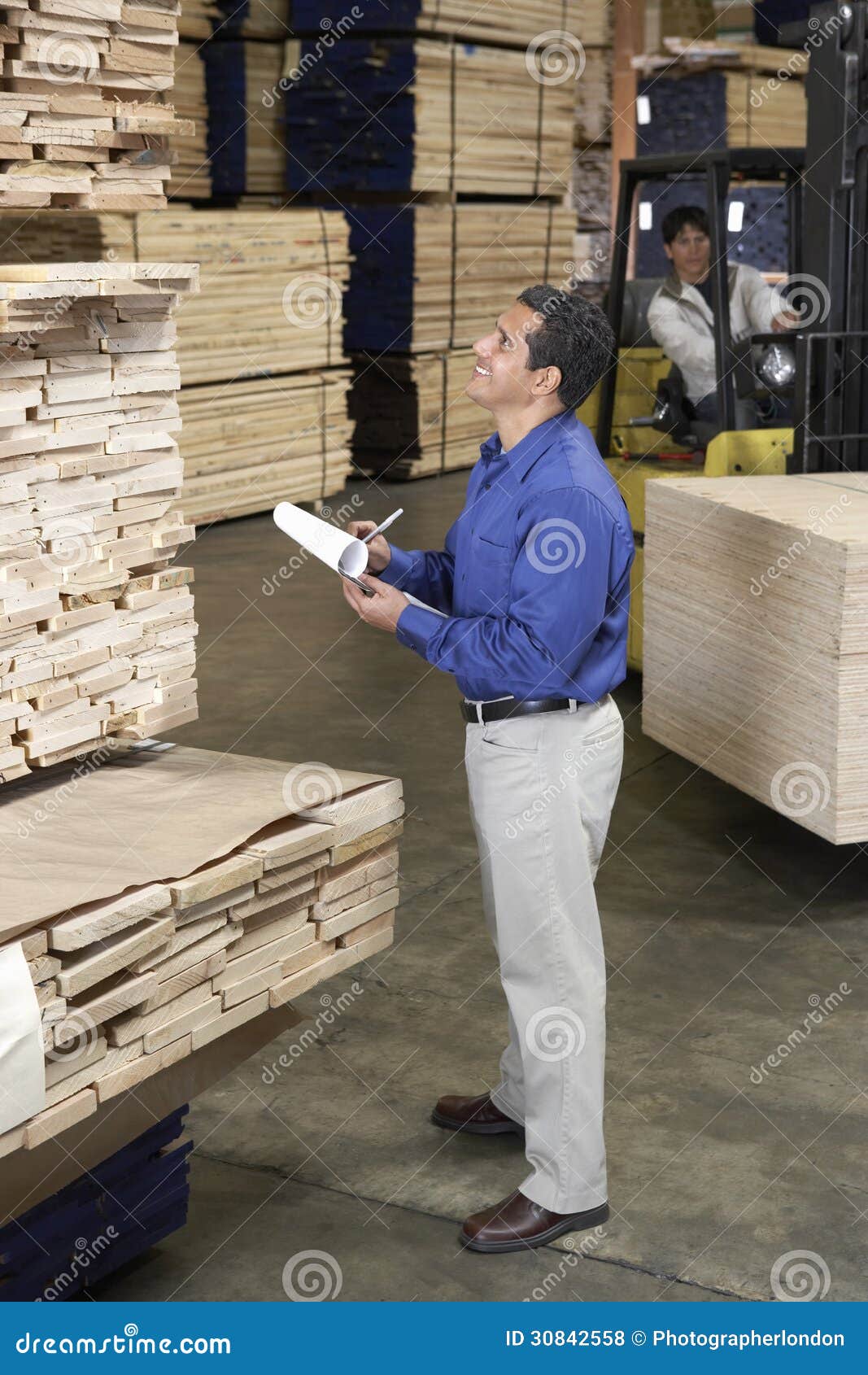Supervisor Checking Notes in Warehouse Stock Photo - Image of stack ...