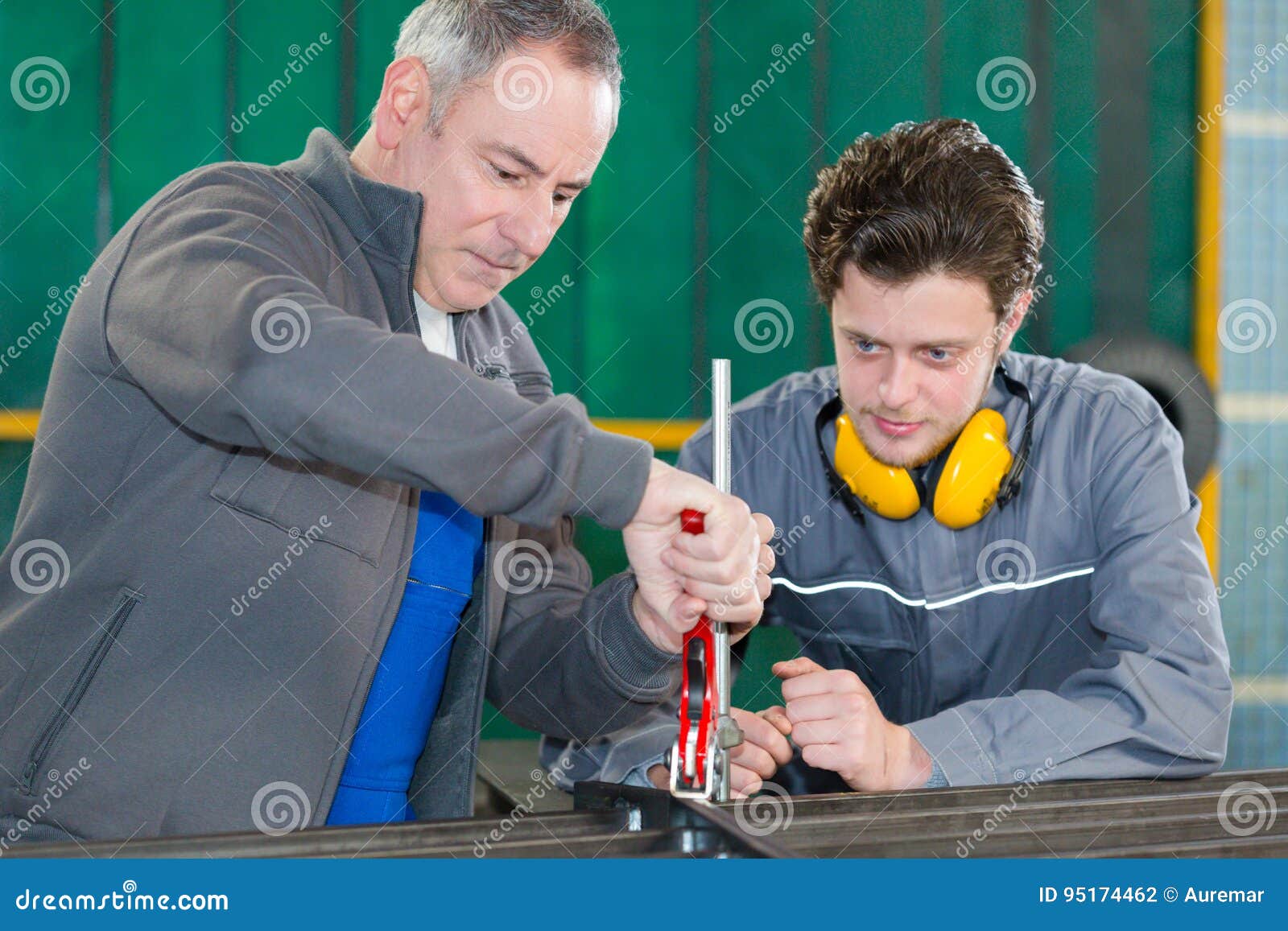 Supervisor Demonstrating Use Tool To Apprentice Stock Photo - Image of ...