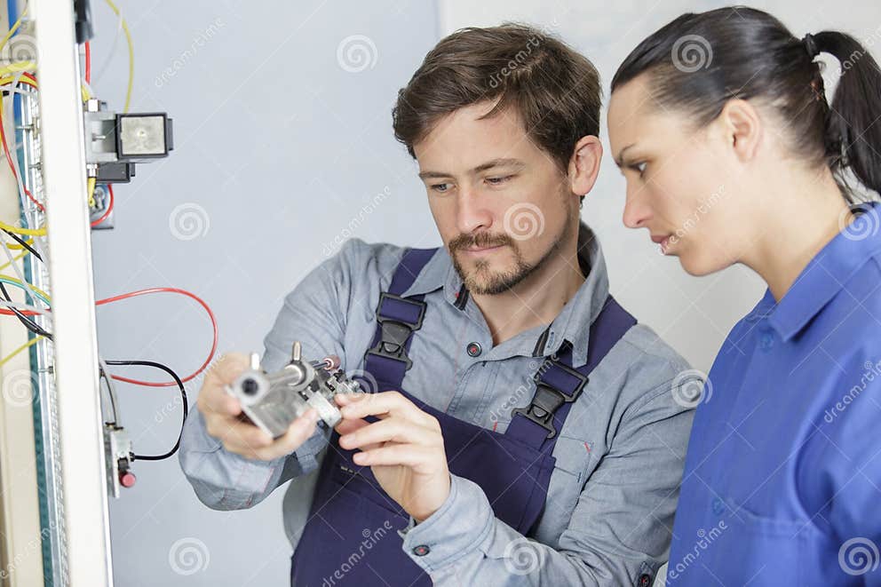 Supervisor Explaining Electronics Compoent To Female Worker Stock Image ...