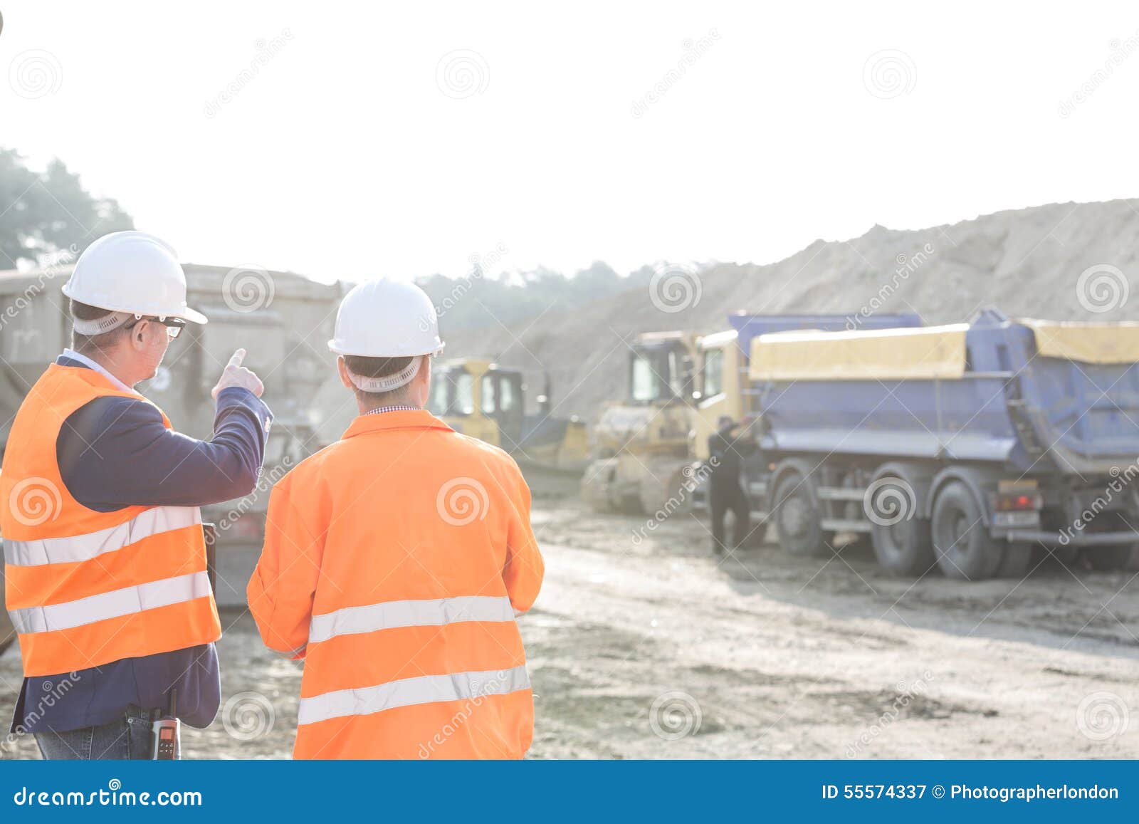 Supervisor Explaining Plan To Colleague at Construction Site Stock ...