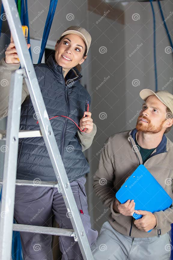 Supervisor Explaining Work To Male Electrician Apprentice Stock Photo ...