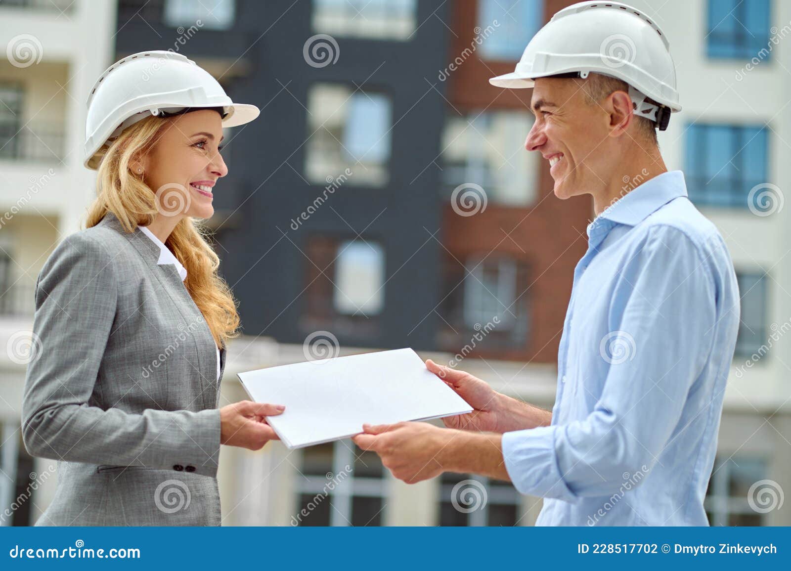Supervisor Handing Over the Building Documentation To a Joyous Worker ...