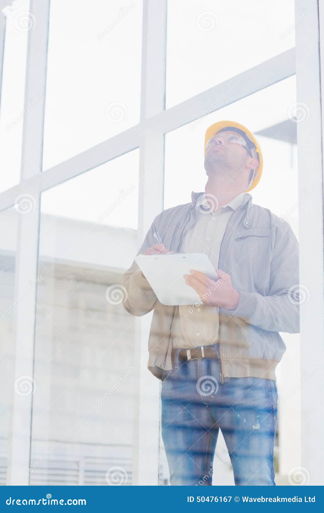 Supervisor Looking Up while Writing on Clipboard Stock Image - Image of ...