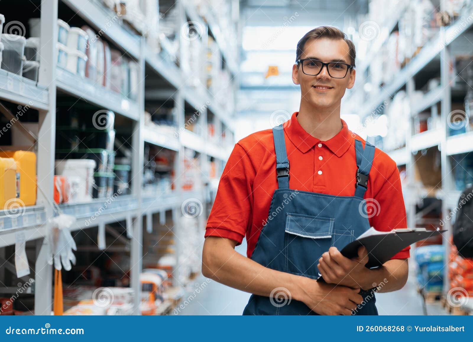 Supervisor Making Notes To the Clipboard while Standing Near a Rack of ...
